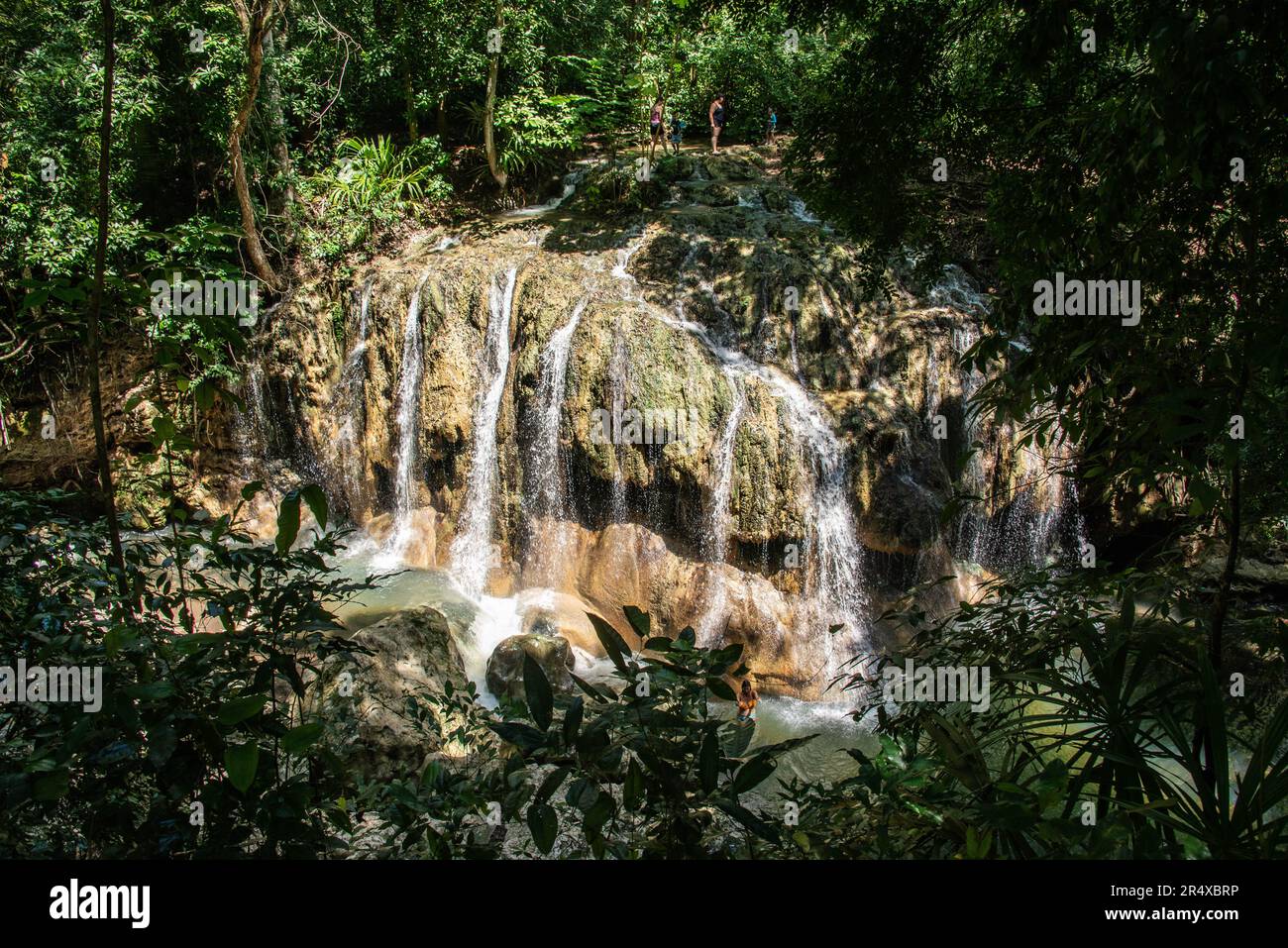 Enjoying the hot spring waterfall of Finca Paraiso, Rio Dulce ...