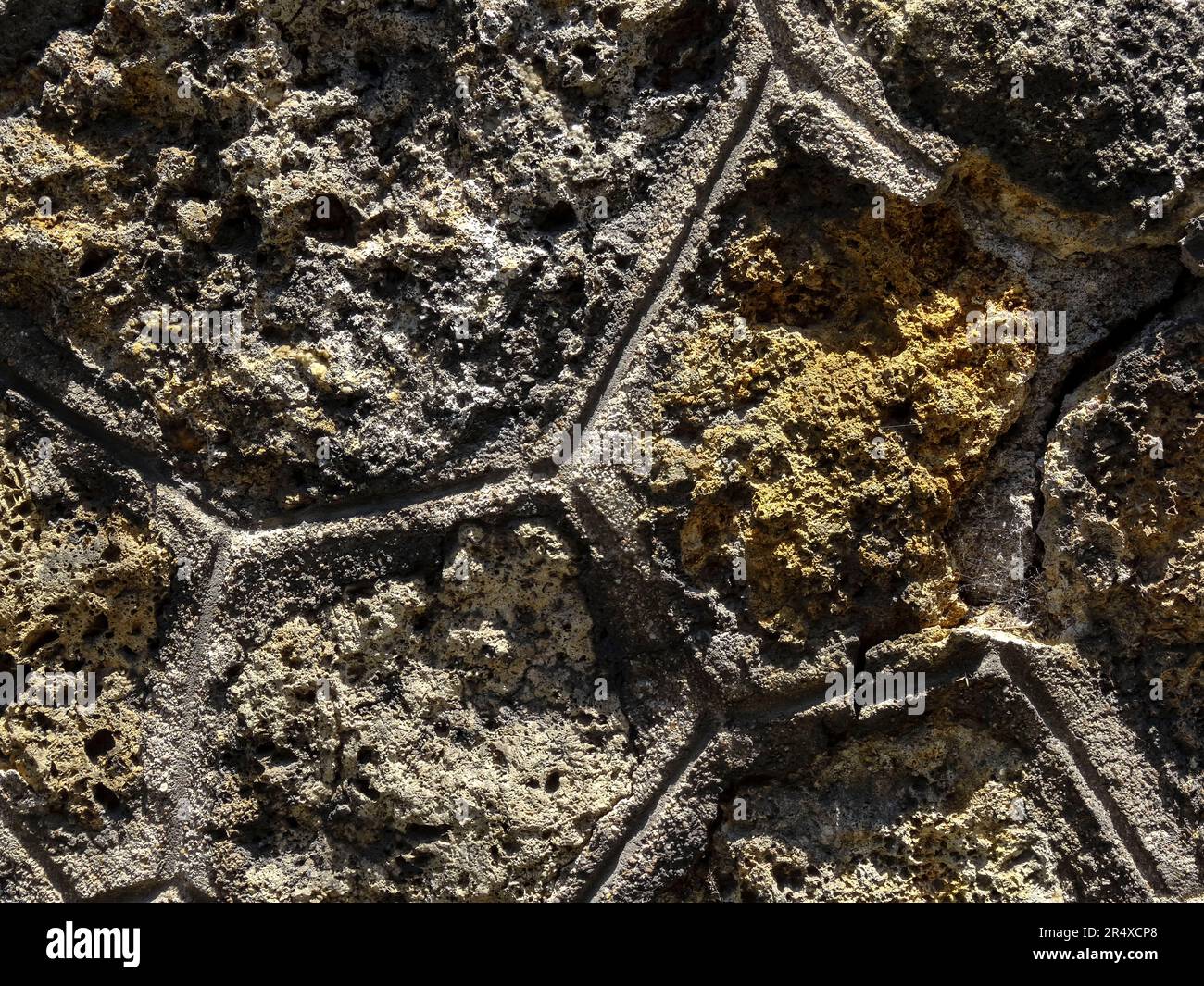 Hard light showing the strong textures in a stone wall and pointing ...