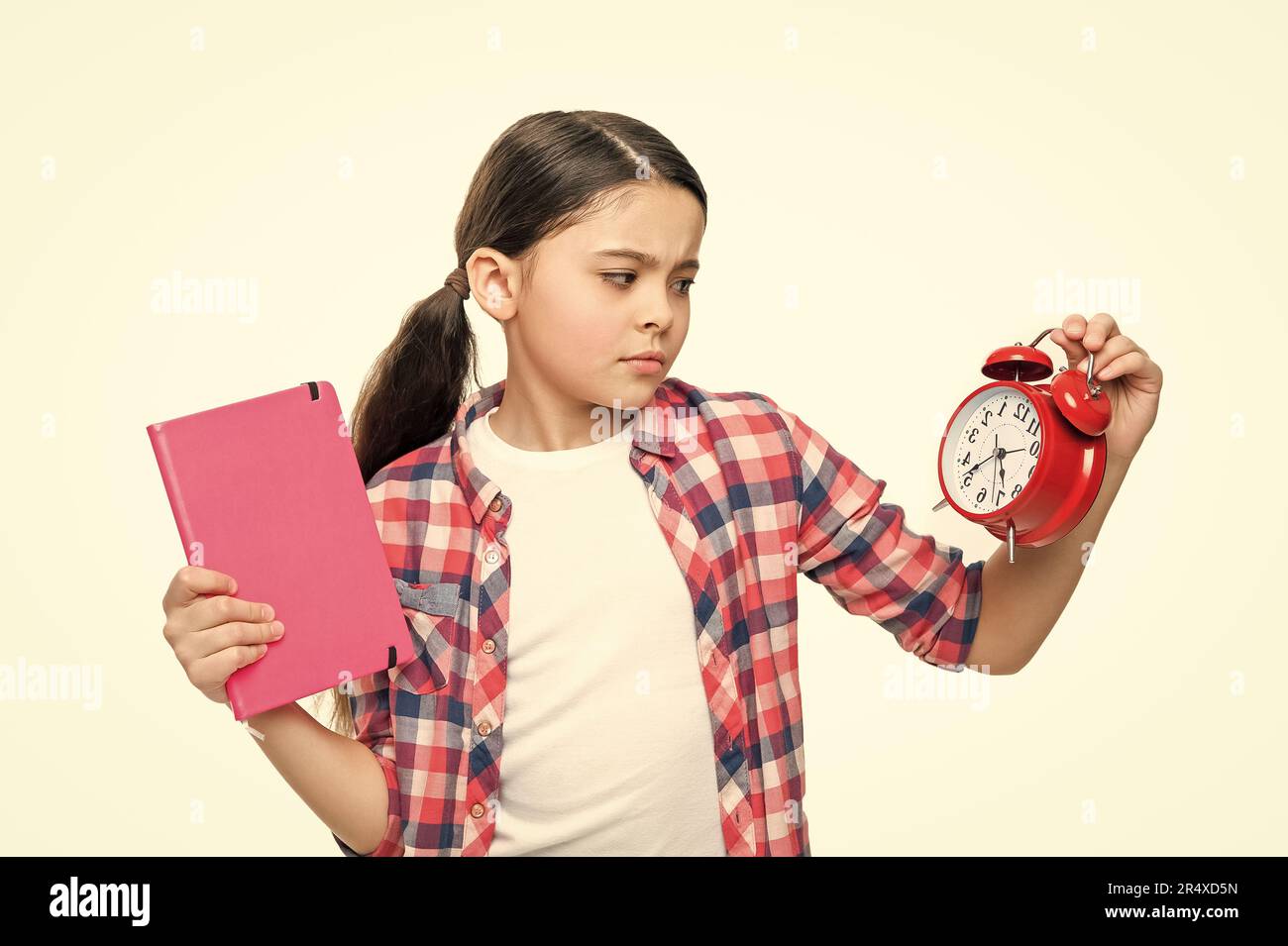 upset school girl with alarm clock in studio. school girl with alarm ...