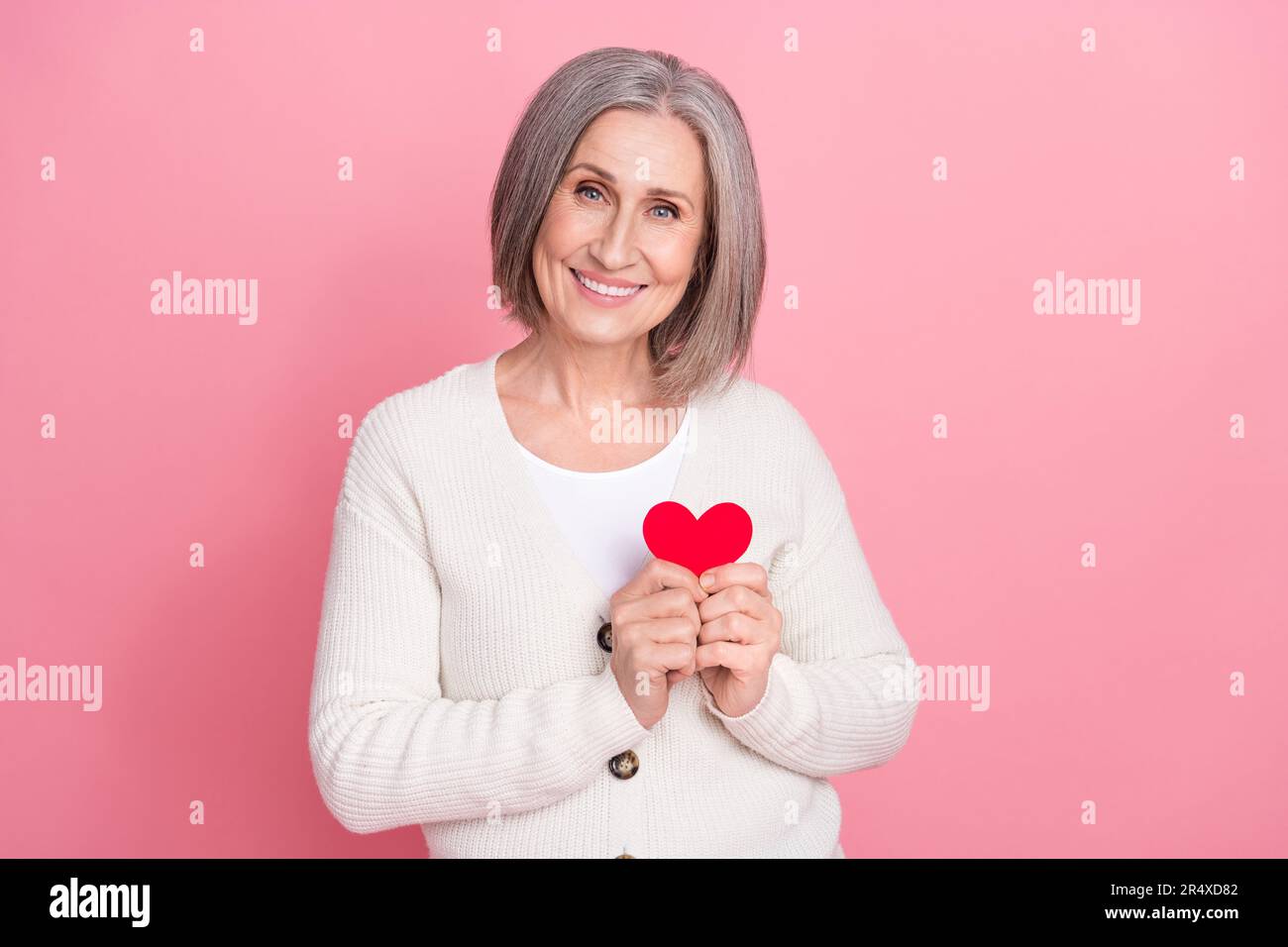 Full length photo of lovely retired lady holding red small healthy ...
