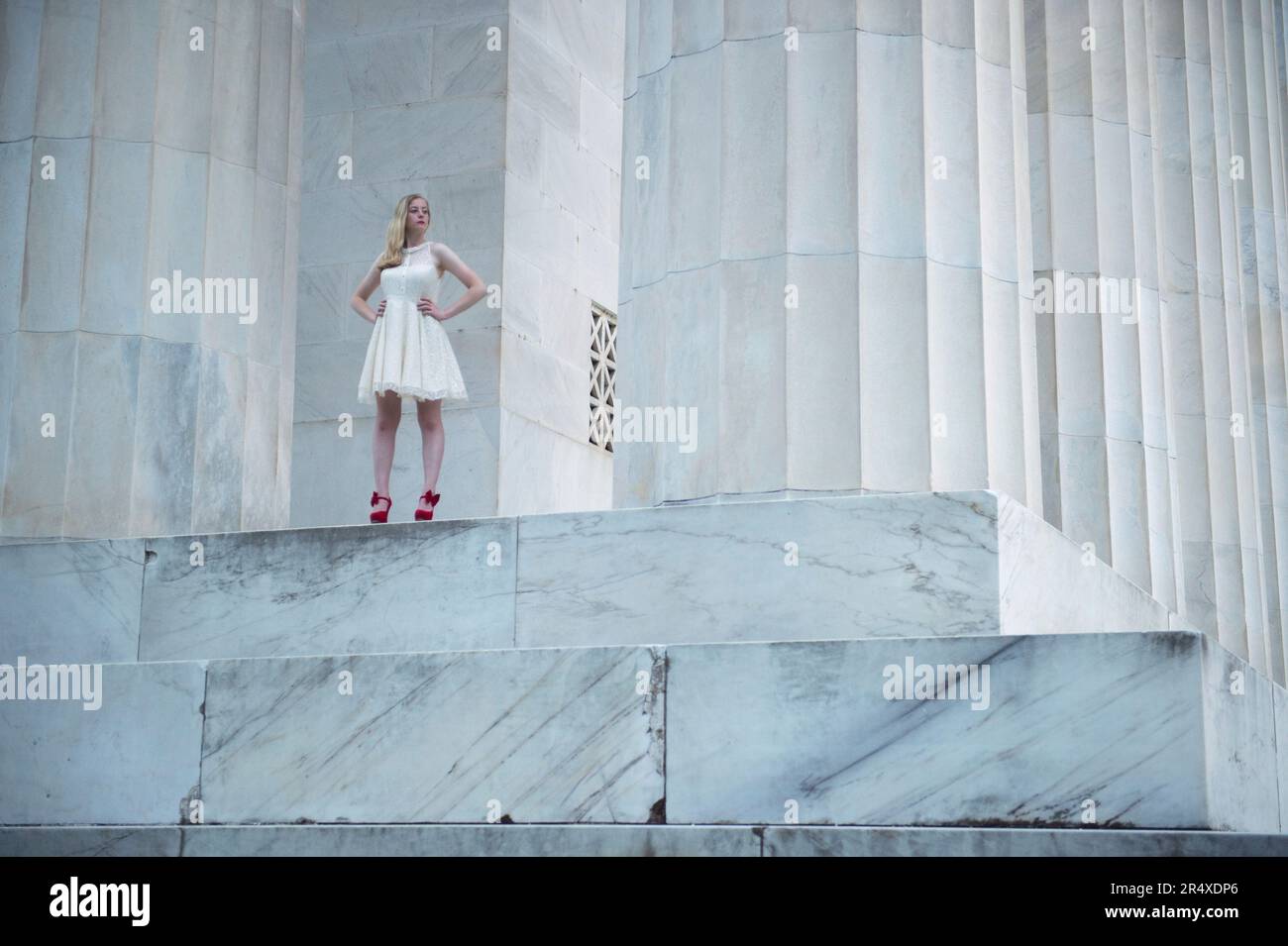 Teenage girl posing in formal wear beside a large column at the Lincoln ...