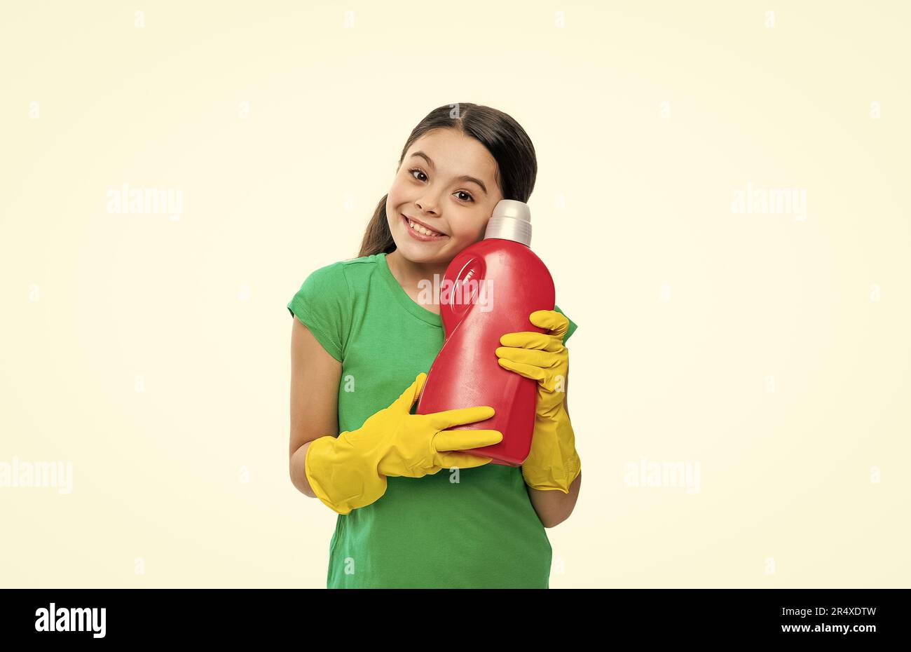 cheerful girl cleaner with detergent in studio. girl cleaner with ...