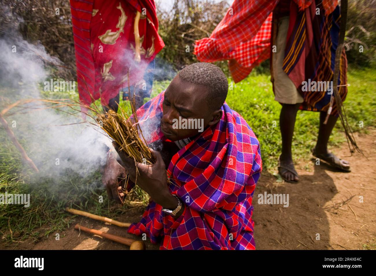 Masai tribesman starting a fire with sticks in Masai Mara National ...