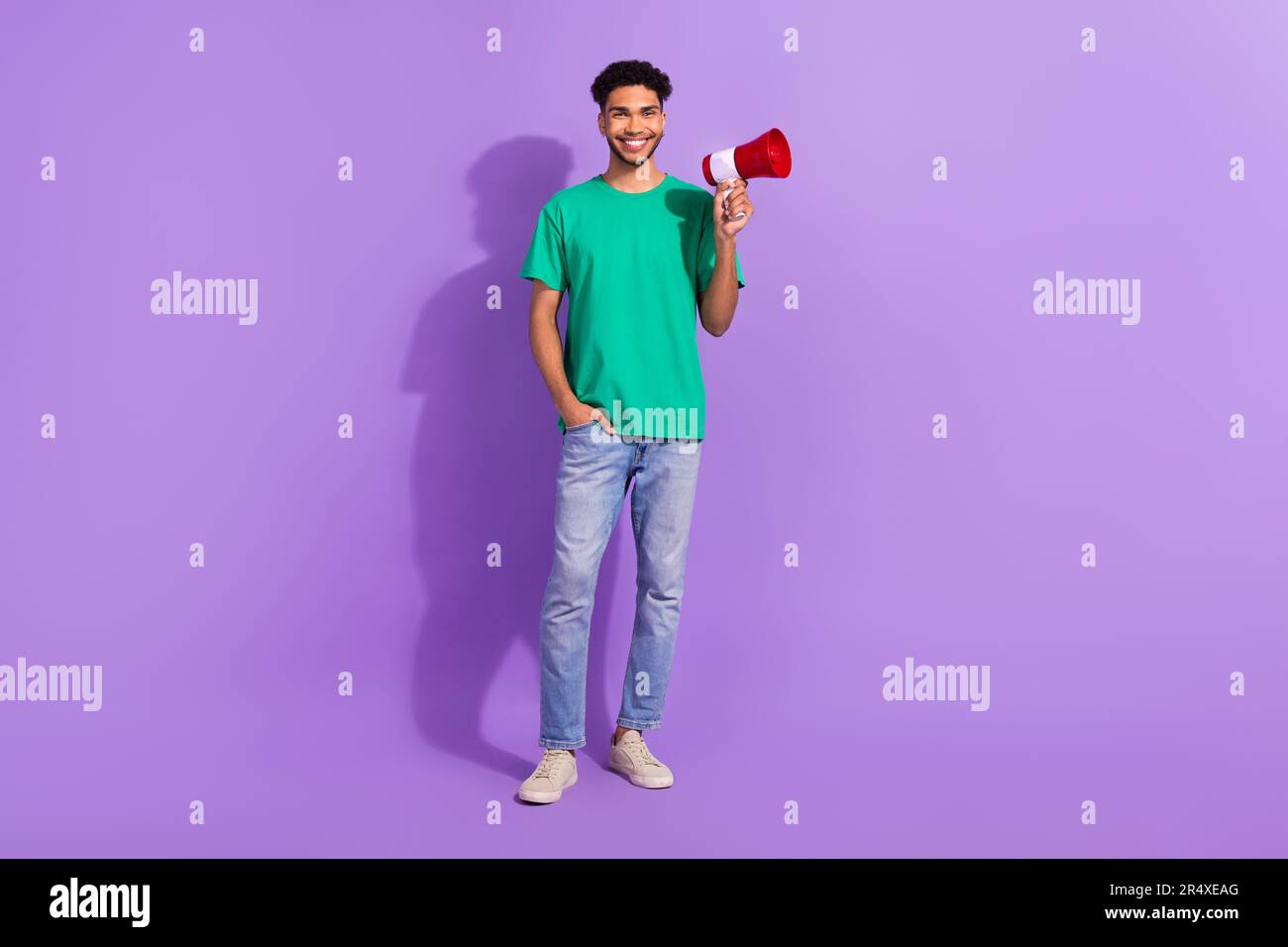 Full body portrait of cheerful nice man hand hold loudspeaker toa ...