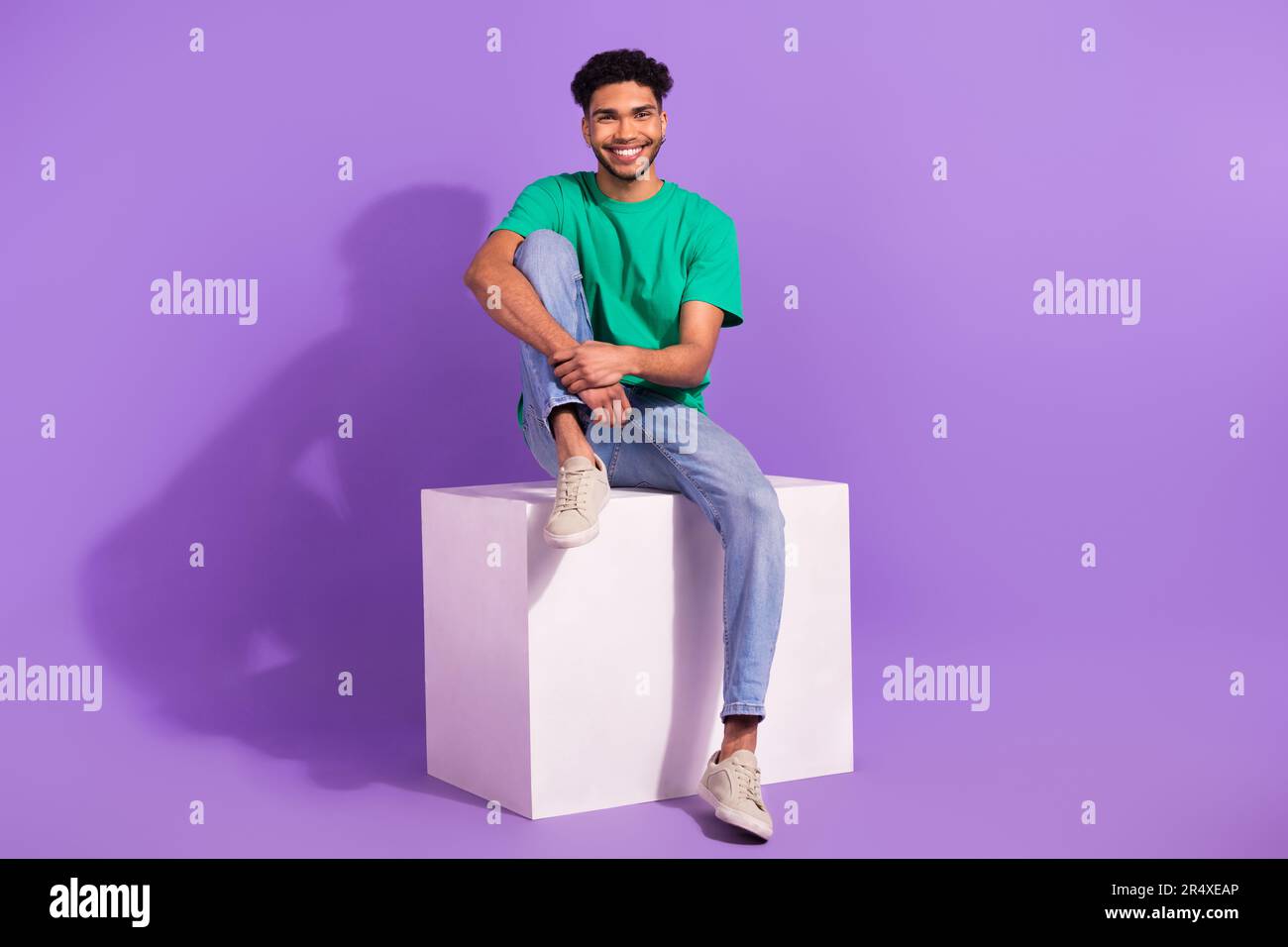 Full body size photo of young cheerful guy sitting platform good mood ...