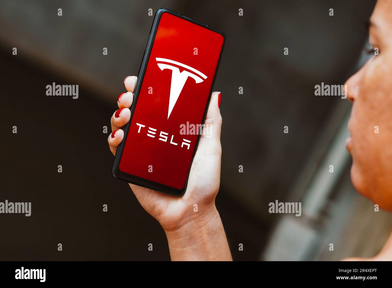 In this photo illustration, the Tesla, Inc. logo is displayed on a ...