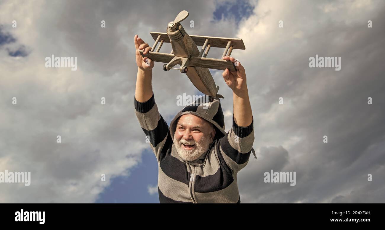 happy retirement. positive granddad with toy. retired old man outdoor ...