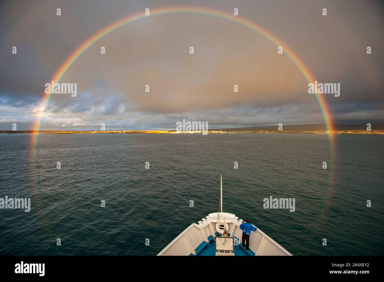 Round rainbow encircles the bow of a small cruise ship in the Galapagos ...