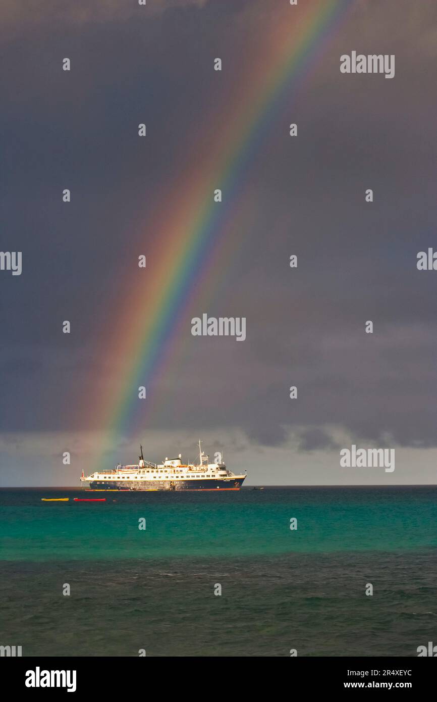 Rainbow shines over a passenger expedition ship in the Galapagos ...
