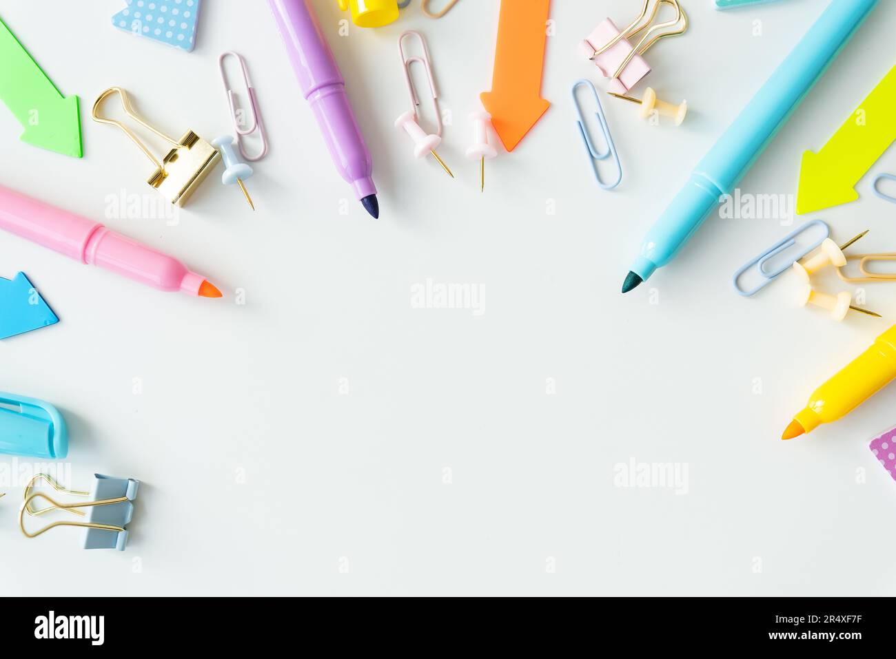 Top view of bright colored school supplies with blank paper for mockup ...