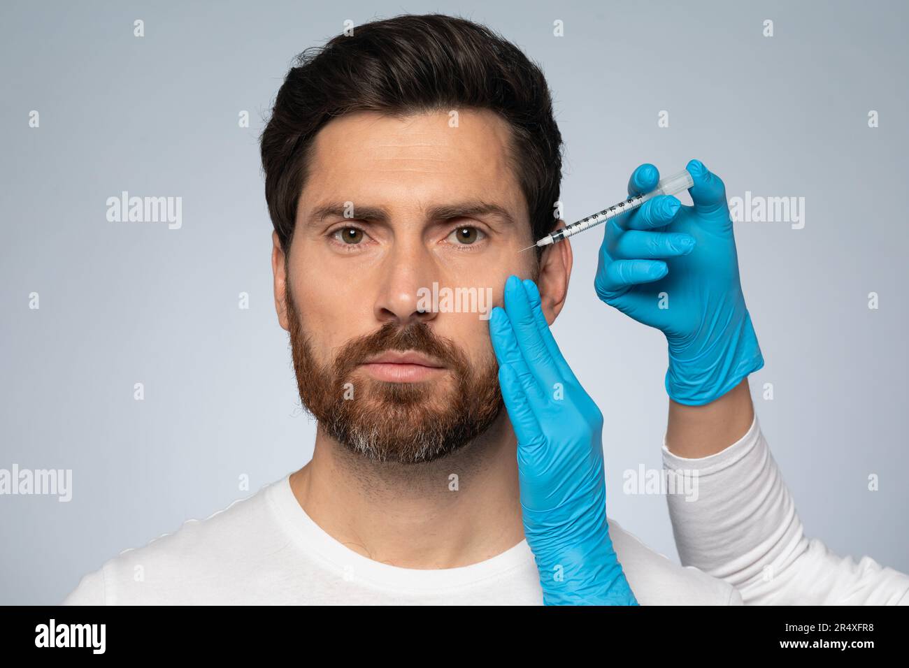 Youthful enhancement. Handsome middle aged man receiving facial beauty ...