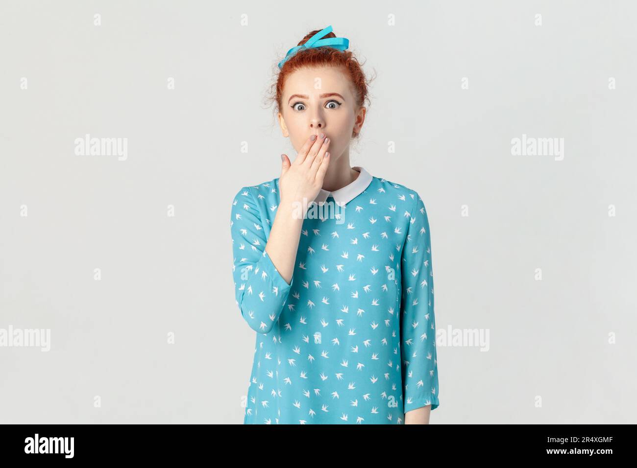 Portrait of shocked astonished adorable ginger woman with bun hairstyle ...
