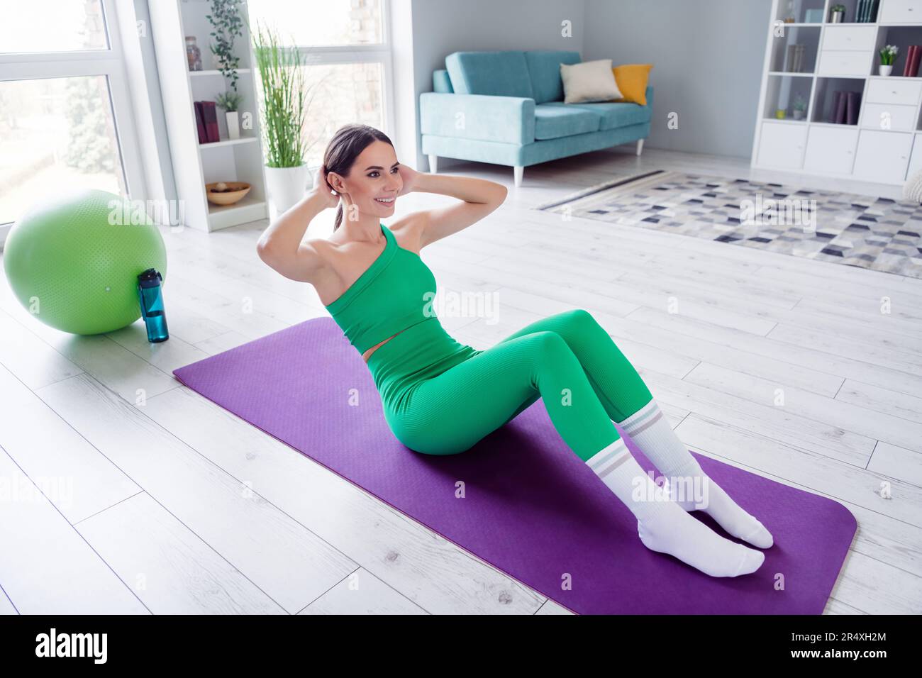 Full size photo of positive determined slender girl doing abs workout ...