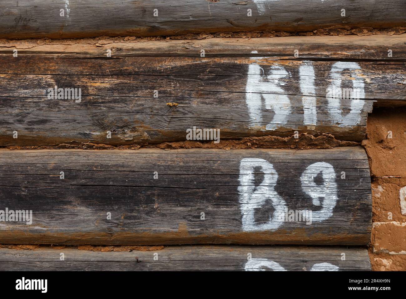 The inscription on the old log wall. Old wooden log house. Lettering in ...