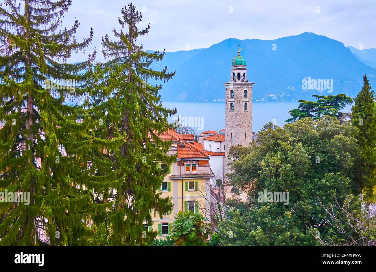 The medieval stone bell tower of St Lawrence Cathedral, Lake Lugano and ...