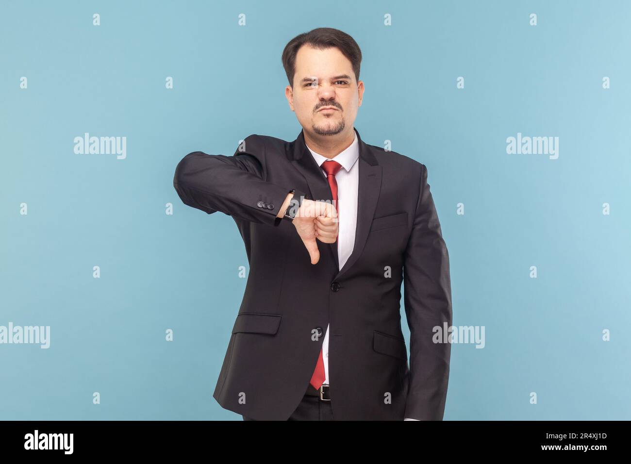 Displeased sad showing man with mustache standing showing dislike ...