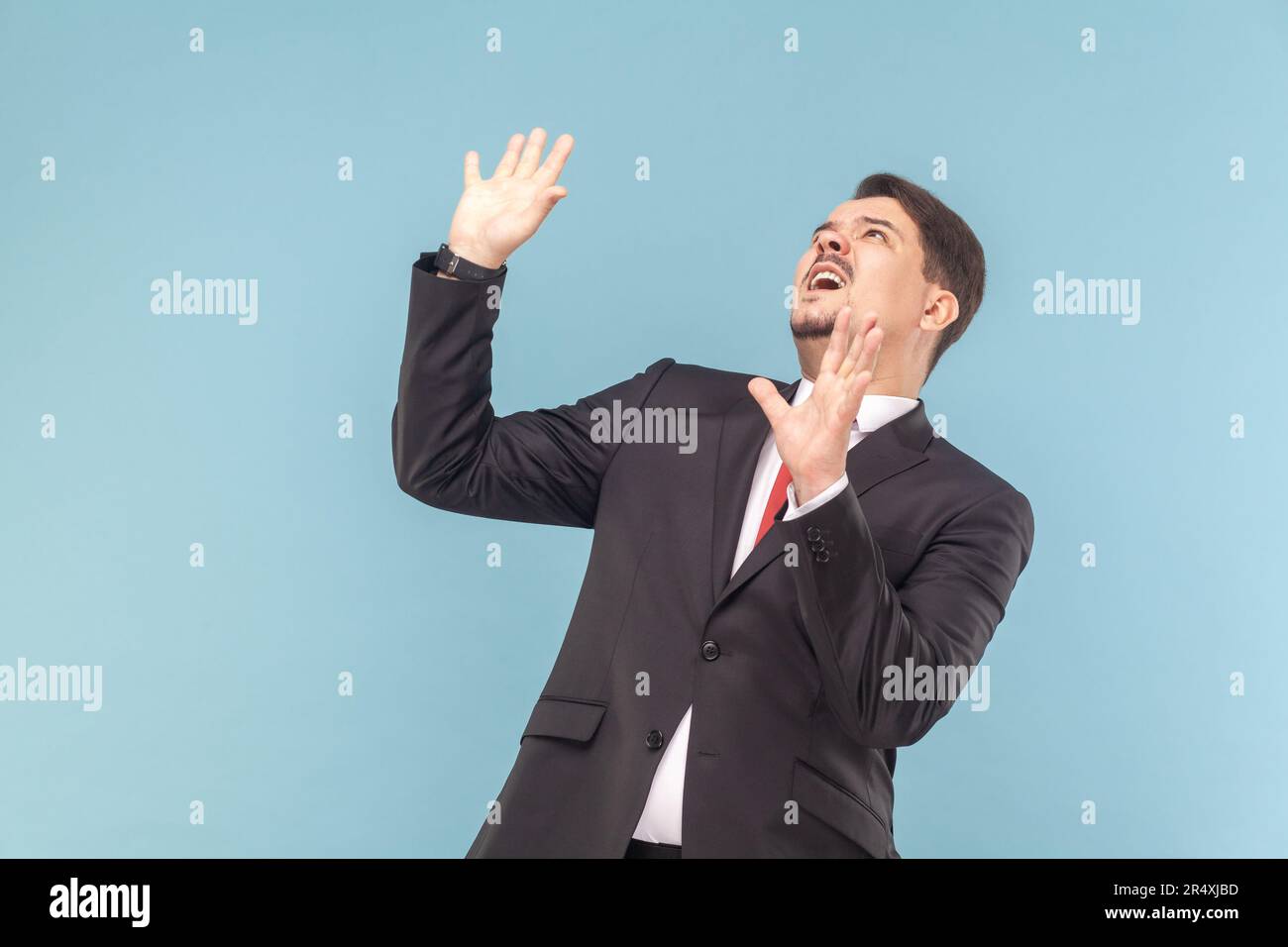 Portrait of sacred frighten man with mustache standing looking up ...