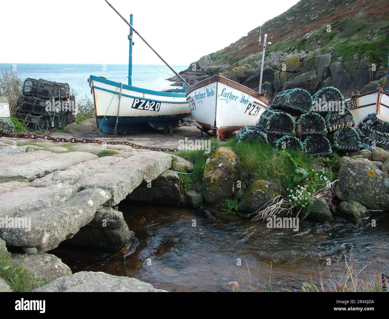 Crab and lobster pots and fishing boats with the old bridge over the ...
