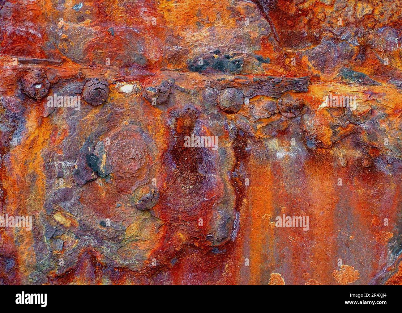 Bright vivid colours created by the rusting of the old steel plates of ...