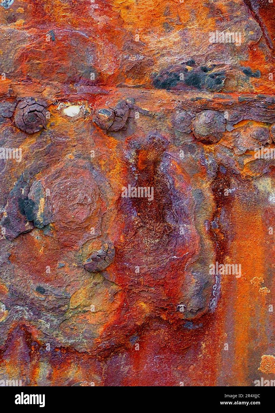 Bright vivid colours created by the rusting of the old steel plates of ...