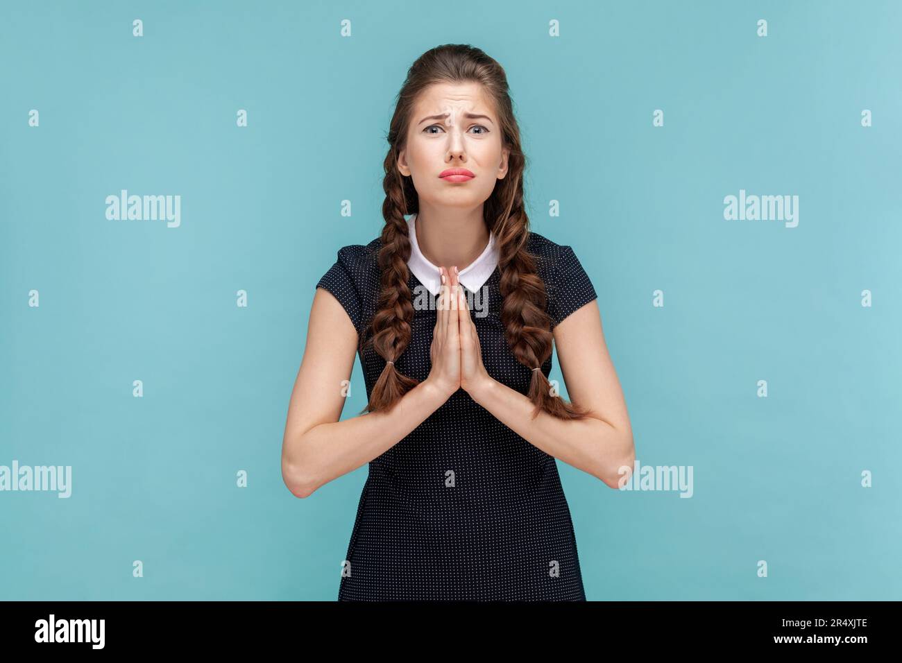 Portrait of hopeful uneasy woman with braids begging for forgiveness ...
