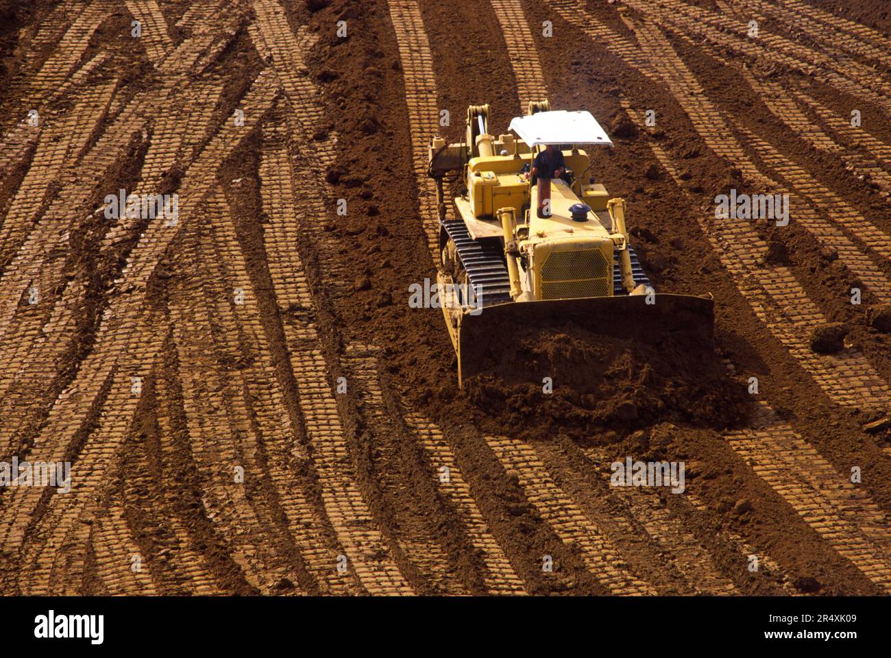 Elevated view of bulldozer and it's tracks on cleared land; United ...