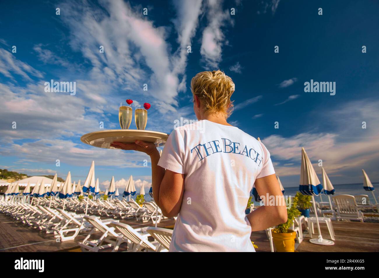 Server with a tray of cocktails on the beach in Nice, France; Nice ...