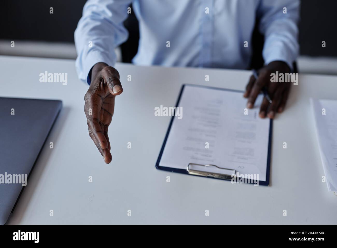 Closeup of black businessman stretching hand to camera for handshake at ...