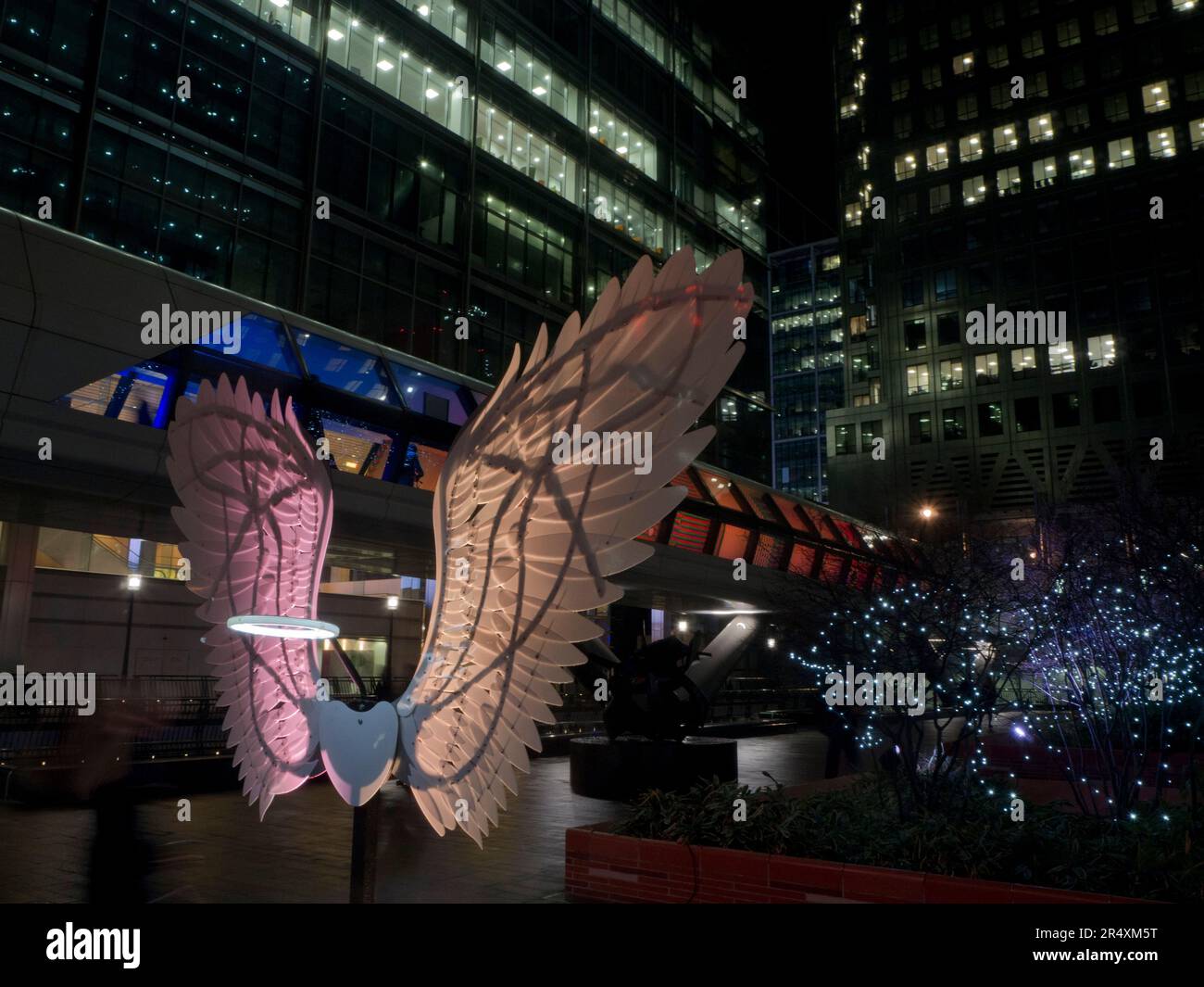 Illuminated white and pink angel wings and aureola installation ...
