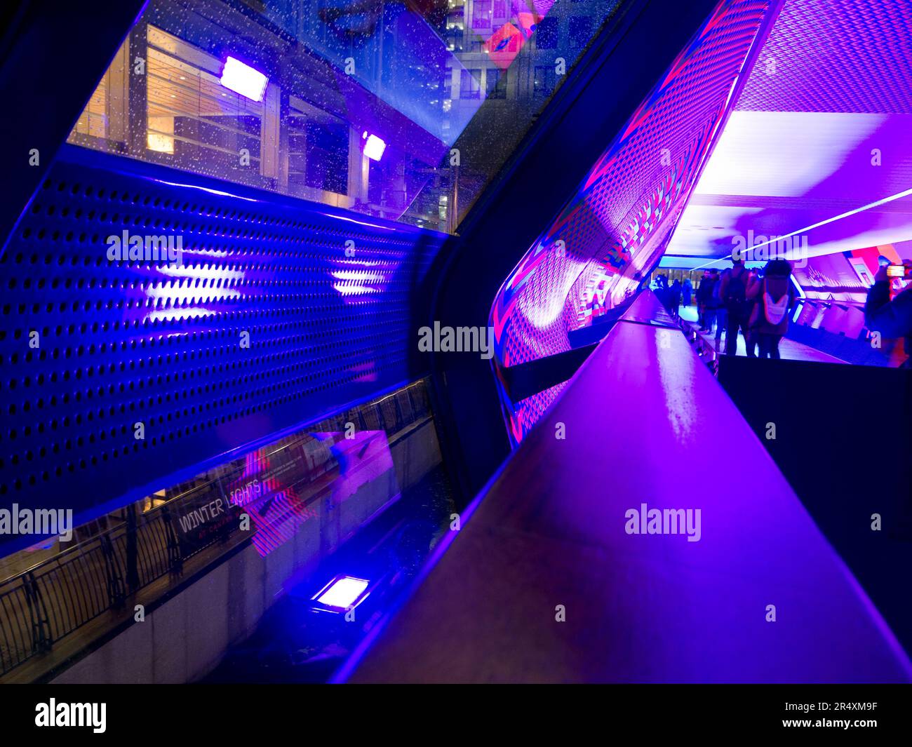 Blue and purple light pedestrian tunnel leading to tube station at ...