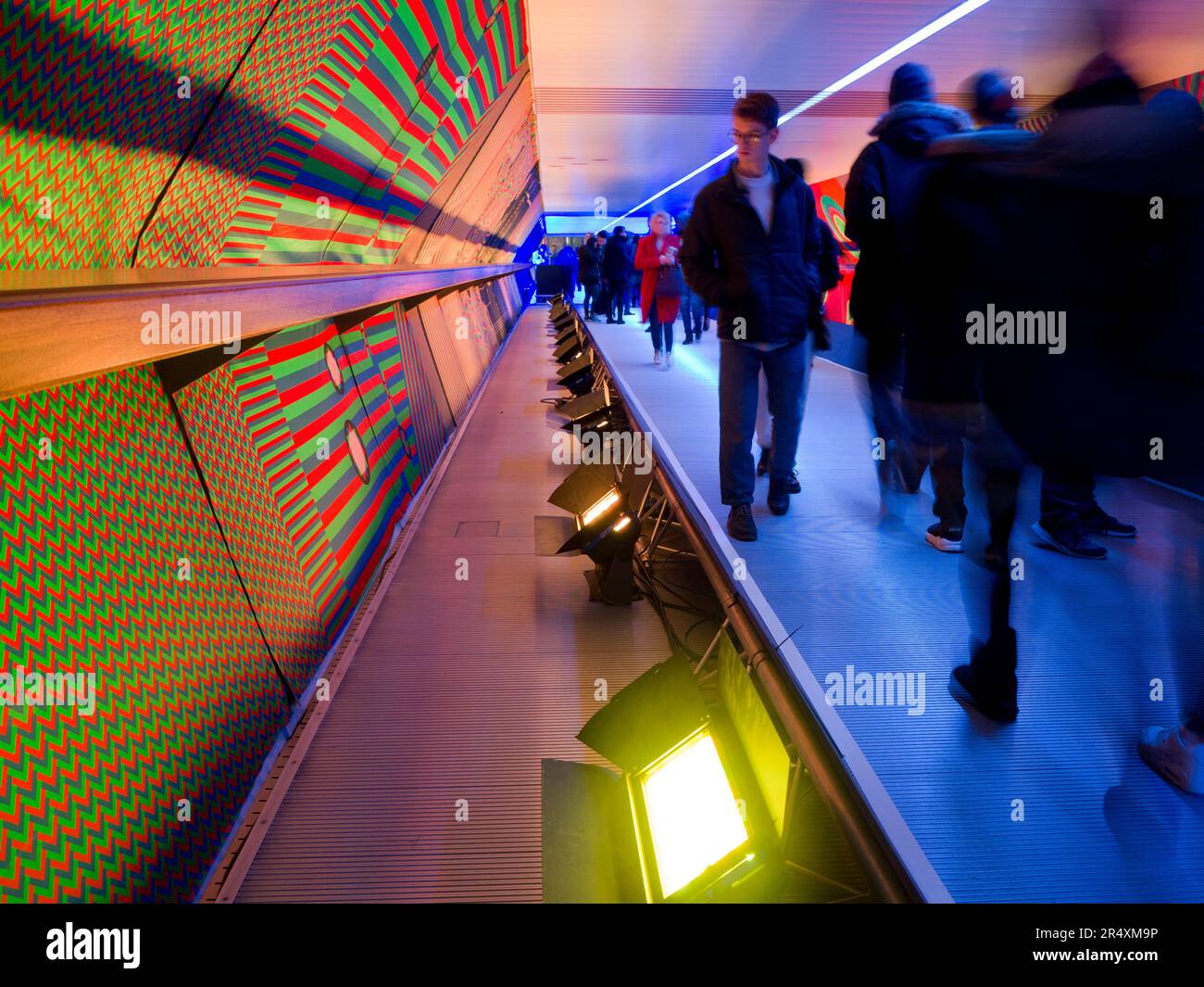 Purple, blue and green light pedestrian tunnel leading to tube station ...