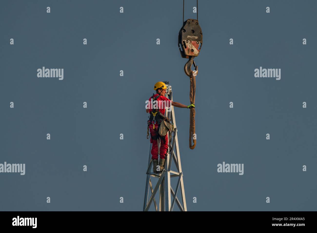 New truss electricity pole with male design engineer with crane and ...