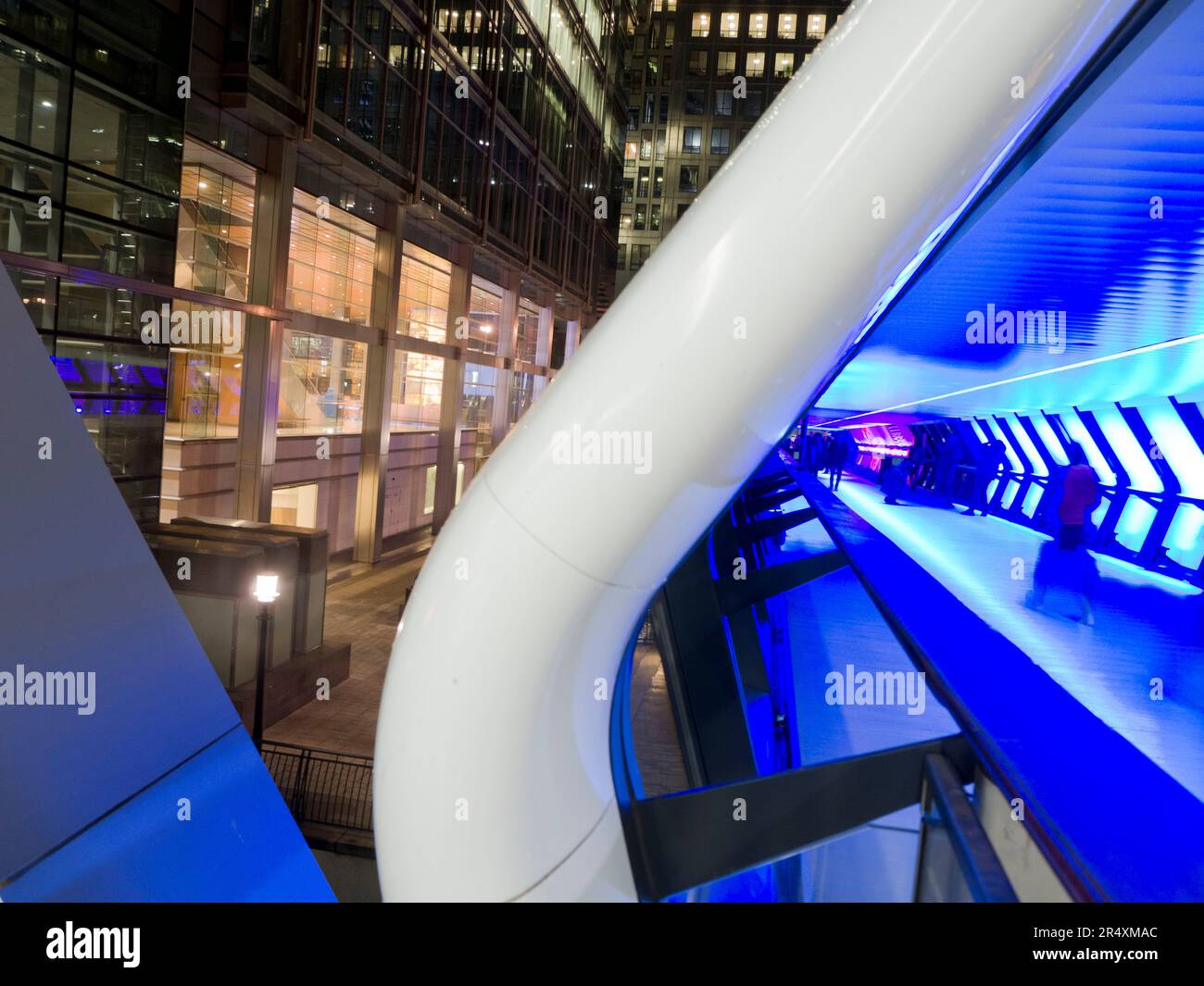 Blue light pedestrian tunnel leading to tube station with modern ...