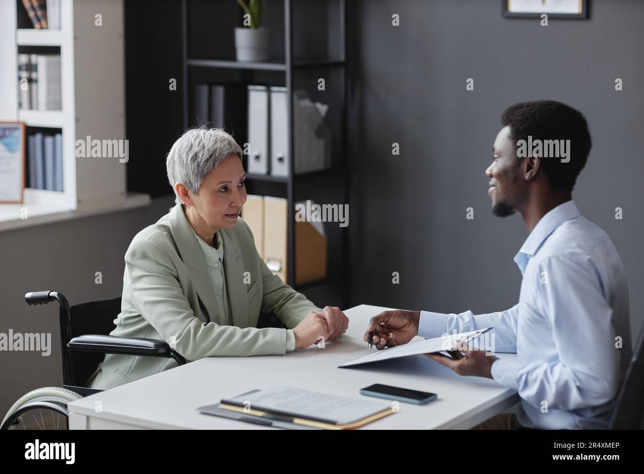 Side view portrait of mature woman with disability speaking to ...