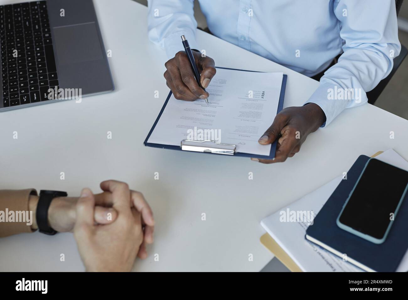 Top view closeup of unrecognizable HR recruiter reviewing CV during job ...