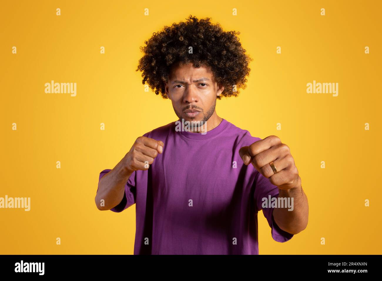 Serious confident mature black curly man wrestler boxer with fists ...