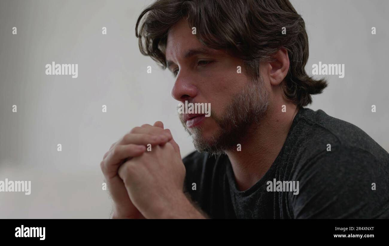 One preoccupied young man thinking deeply about life problematic issues ...