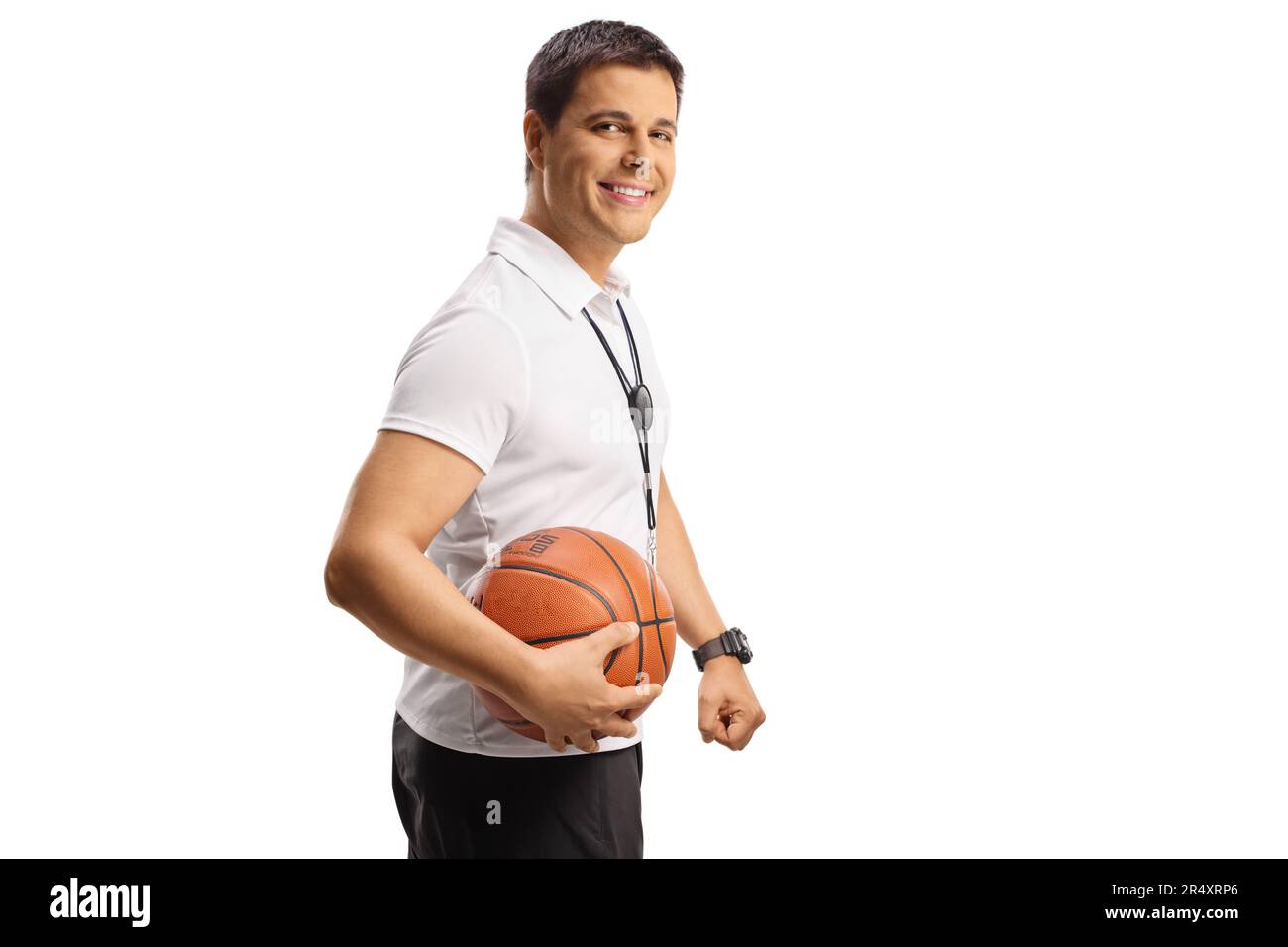 Basketball coach holding a ball and smiling isolated on white ...