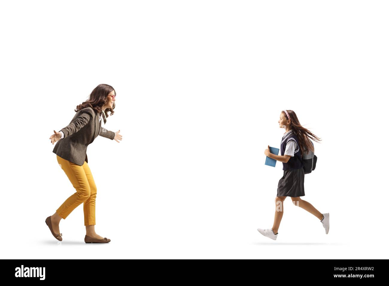 Schoolgirl running to hug a young woman isolated on white background ...