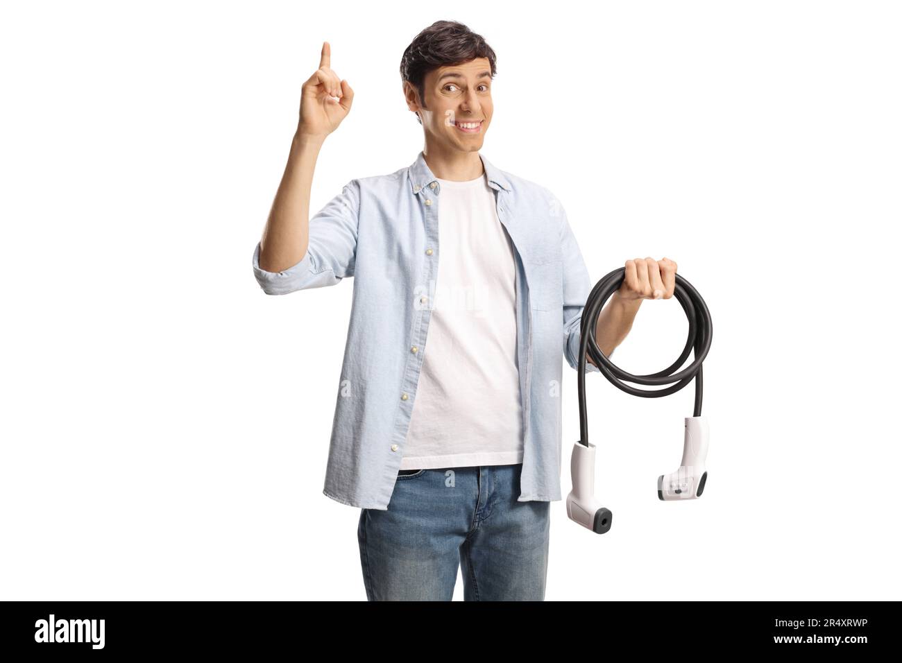 Smiling man holding a cable for electrical vehicle charging and ...