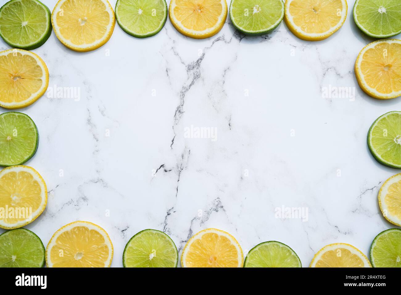 Citrus background, lemon and lime on a marble backdrop, copy space ...