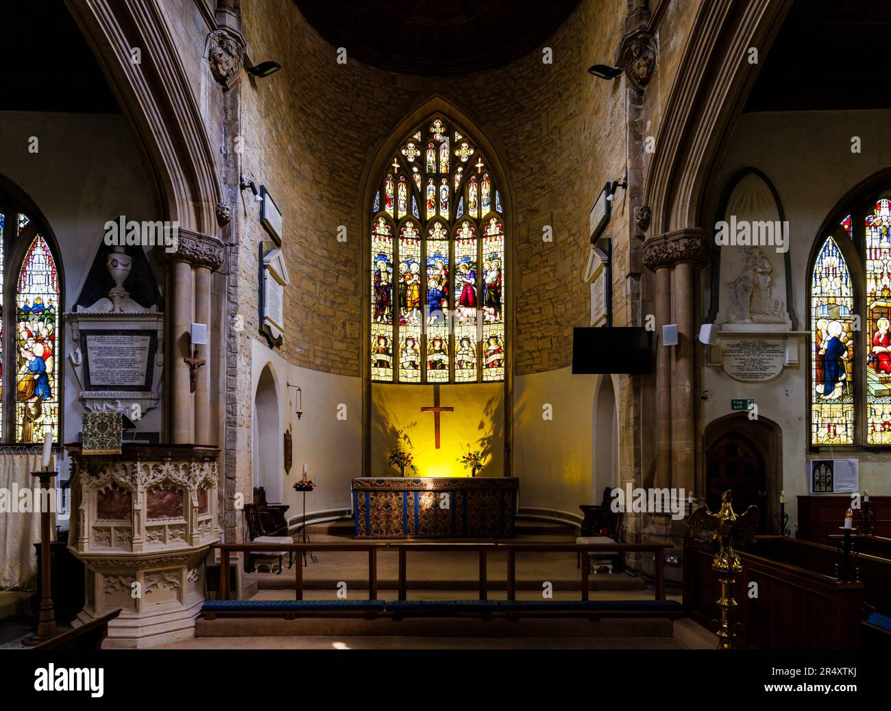 Interior view of the chancel, apse, altar and stained glass windows of ...