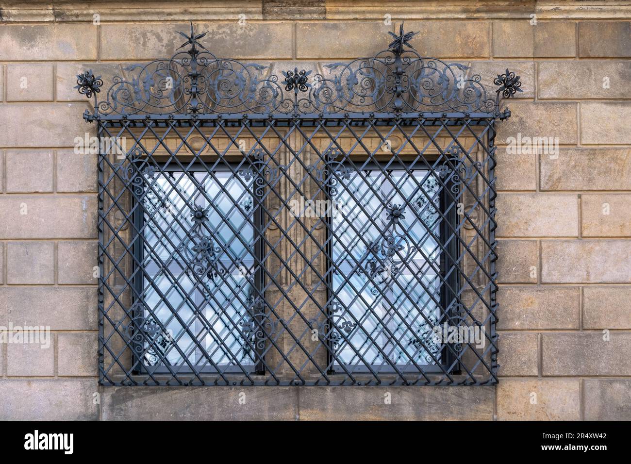 Two rectangular windows. Closed with a figured iron lattice on the ...