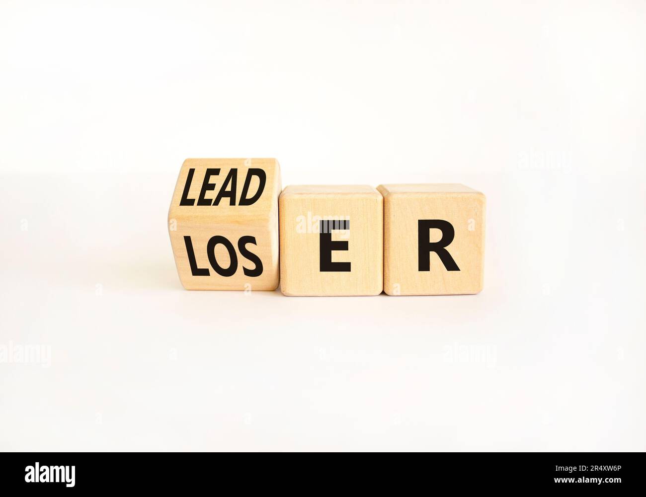 Loser or leader symbol. Businessman turns wooden cubes and changes the ...