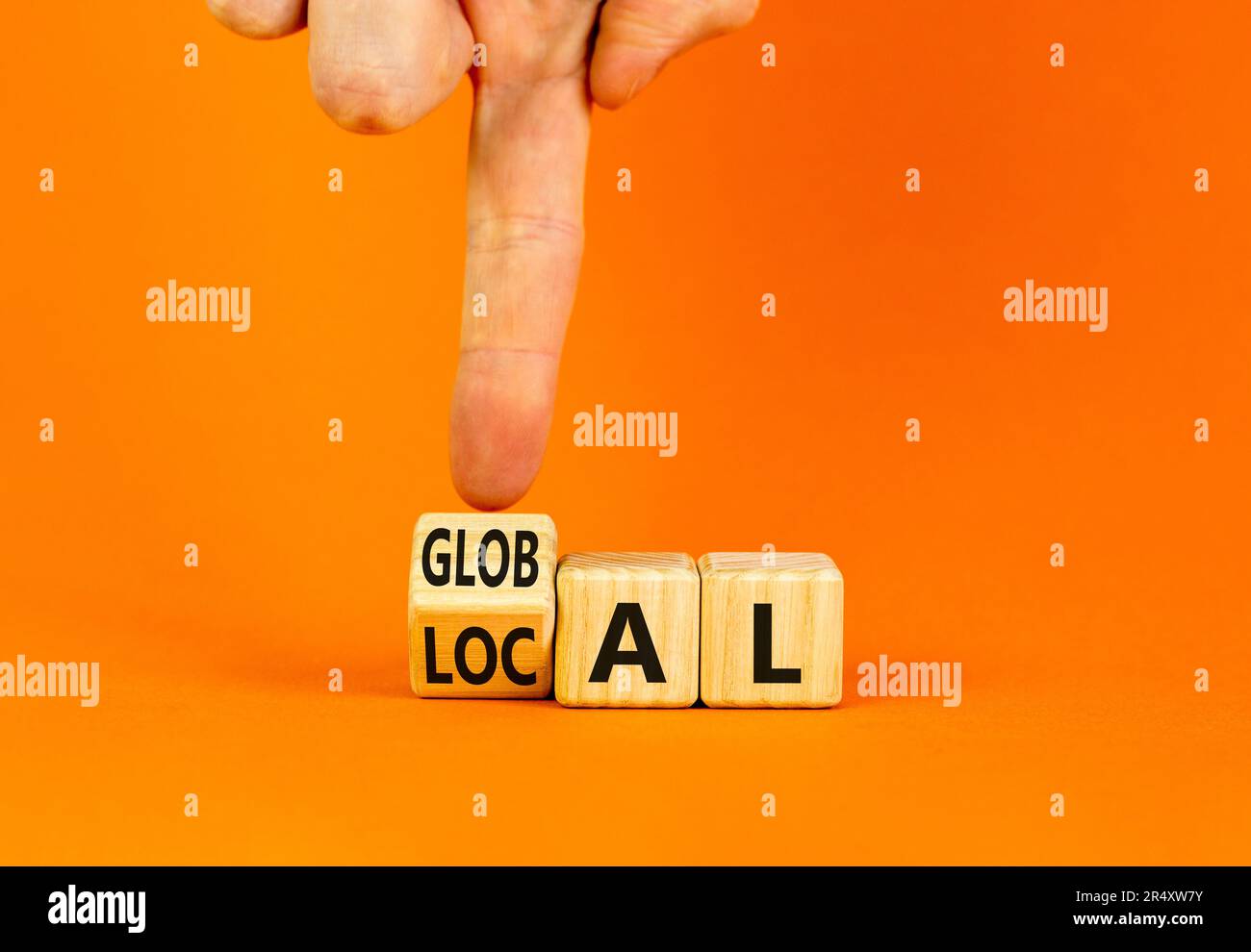 Local or global symbol. Businessman turns wooden cubes and changes the ...