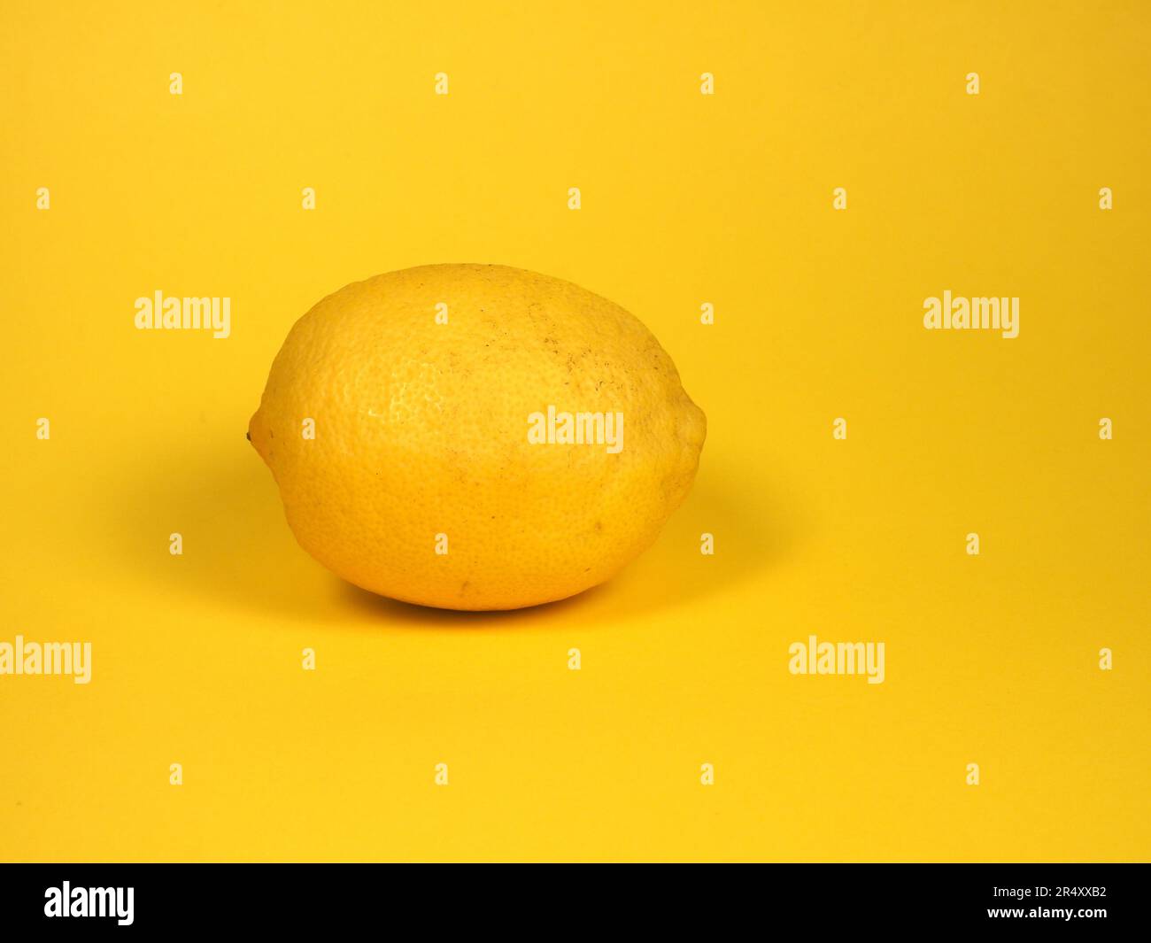 lemon over yellow background with copy space Stock Photo - Alamy