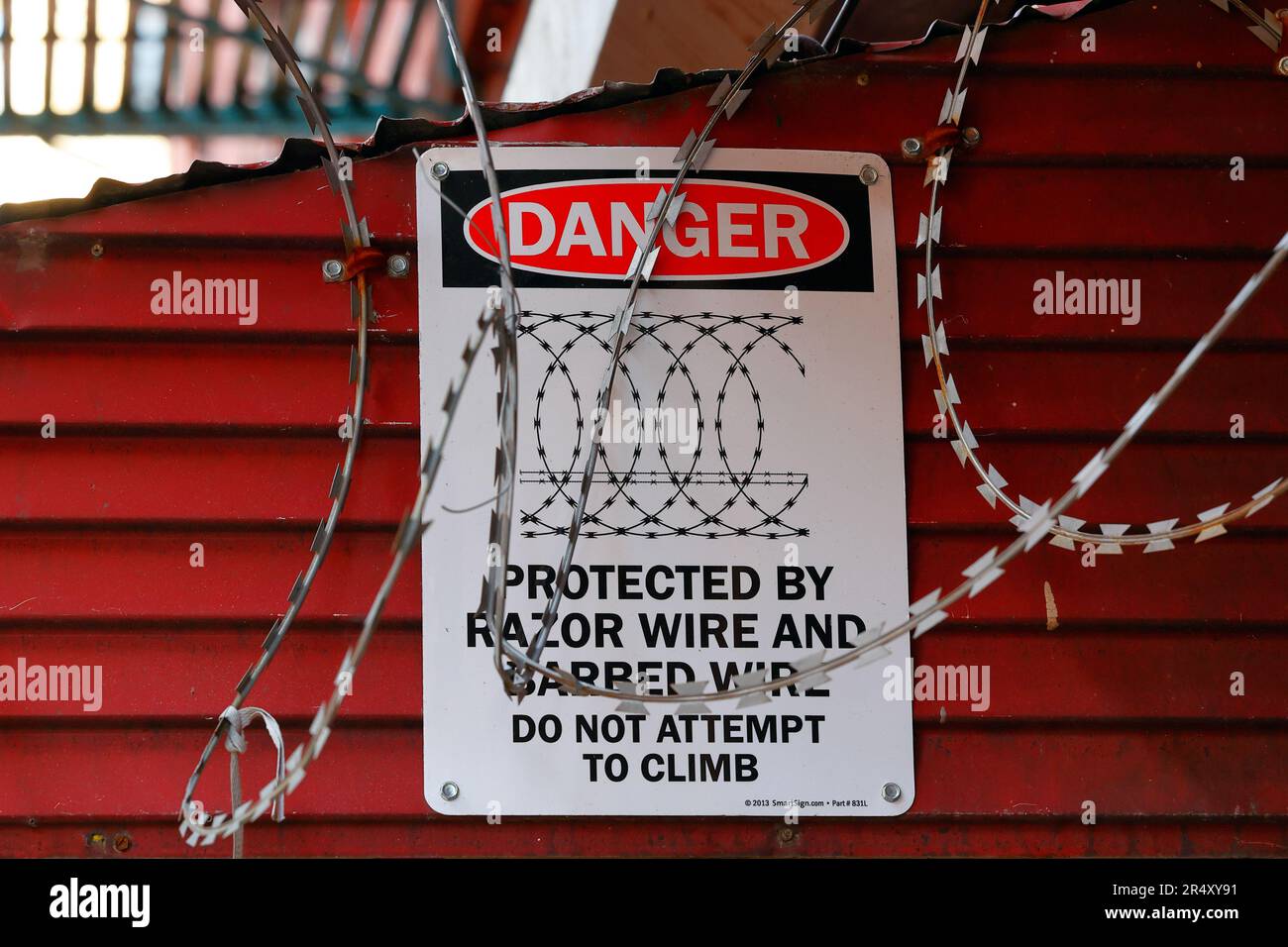 A "Danger, Protected By Razor Wire And Barbed Wire, Do Not Attempt To ...