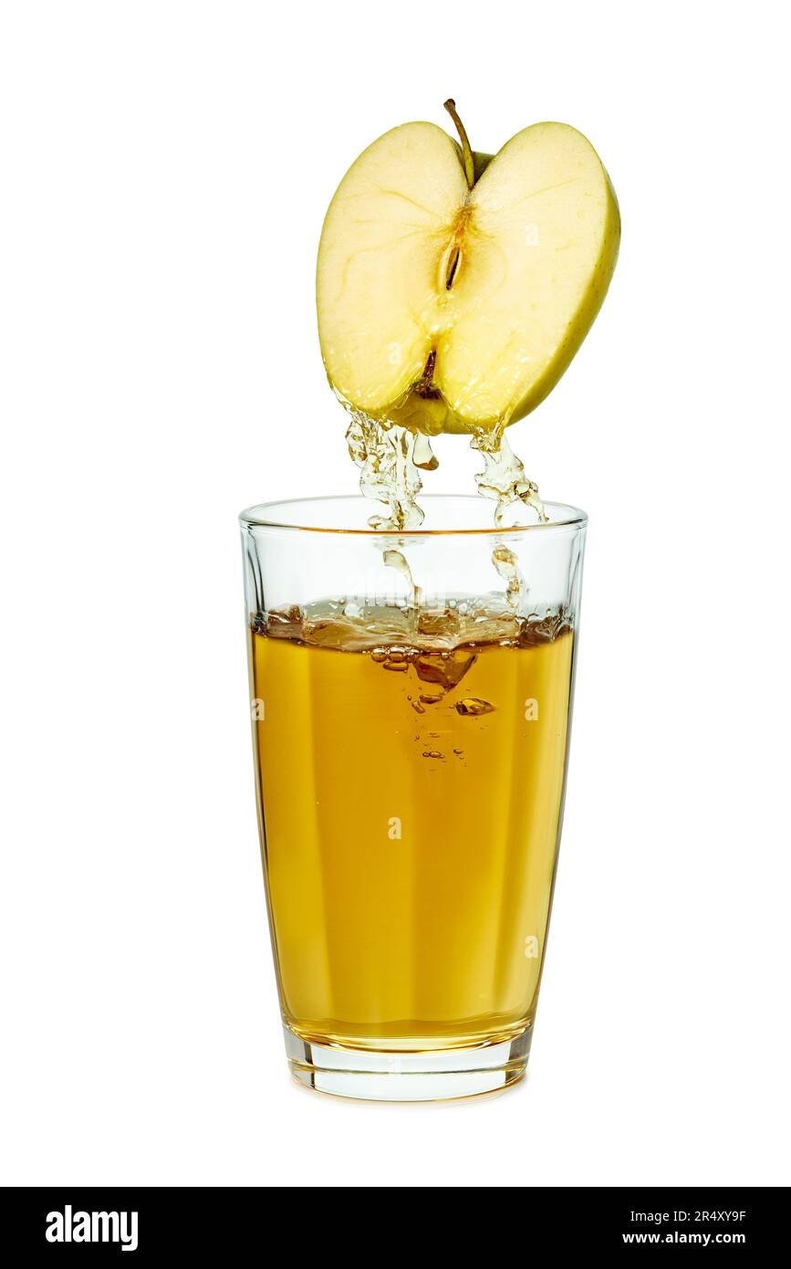 Juice poring from apple half to glass on white background Stock Photo ...