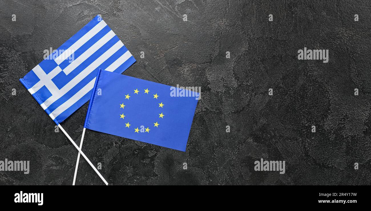 Flags of European Union and Greece on dark background with space for ...