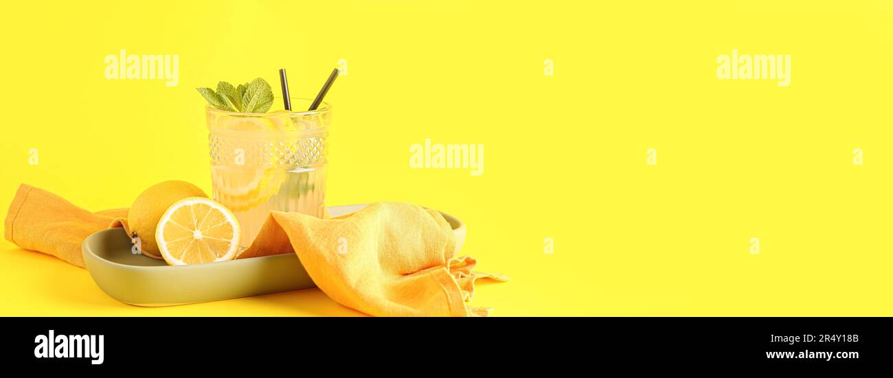 Glass of fresh lemonade on yellow background with space for text Stock ...